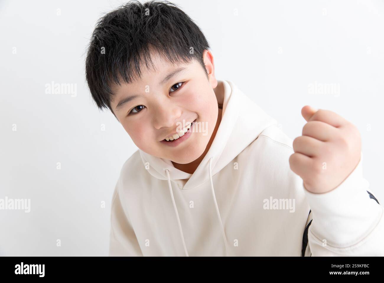 Boy striking a Guts Pose Stock Photo - Alamy