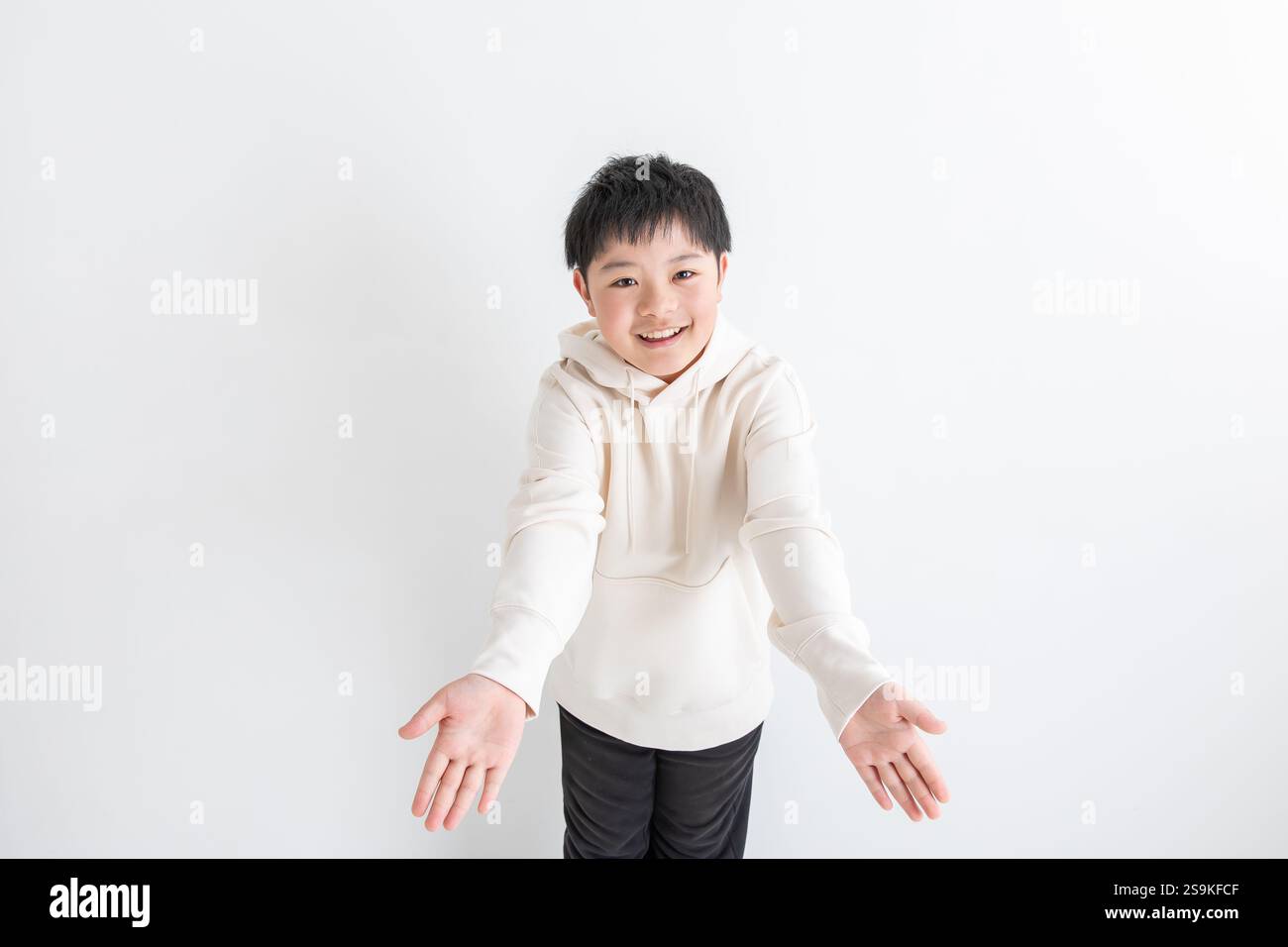 Primary school boy posing for ‘please’ Stock Photo - Alamy
