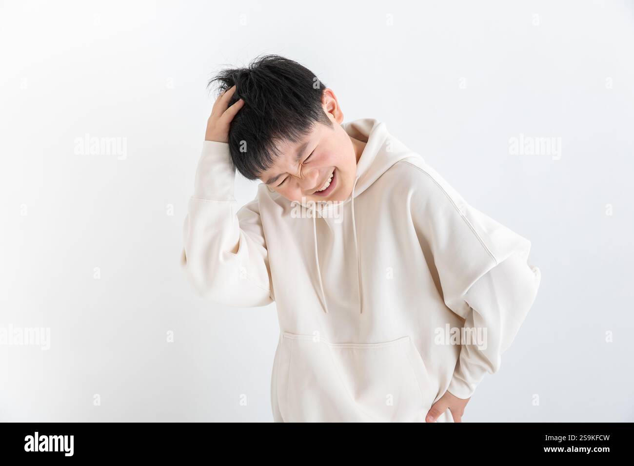 Boy with head held in frustration Stock Photo - Alamy