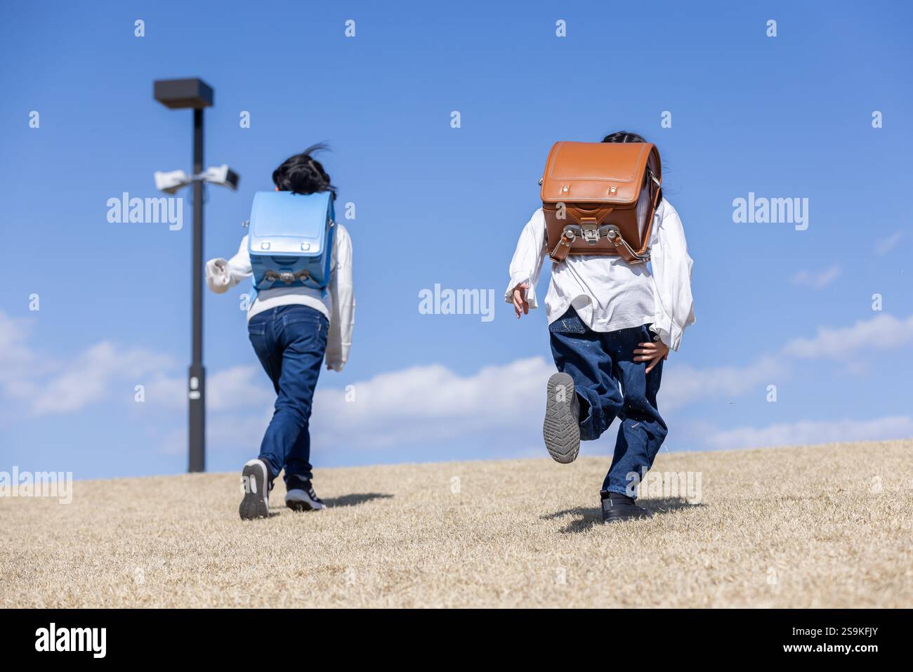Elementary school student running away Stock Photo - Alamy