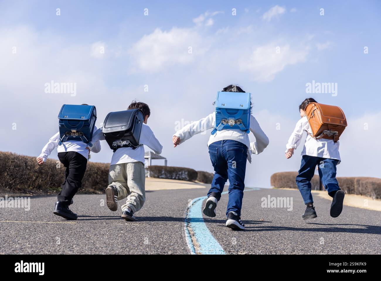 Elementary school student running away Stock Photo - Alamy