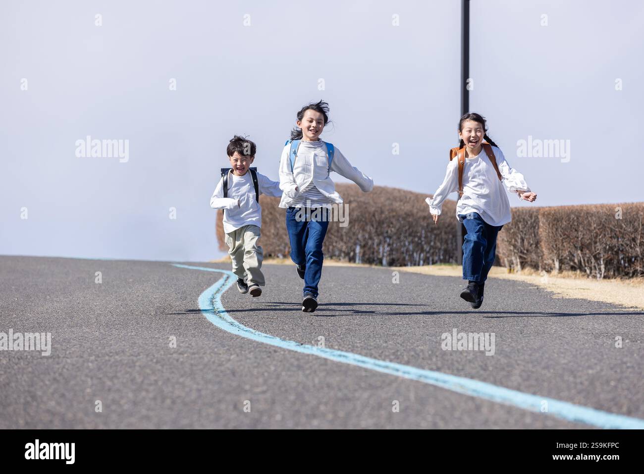 Elementary school student running away Stock Photo - Alamy