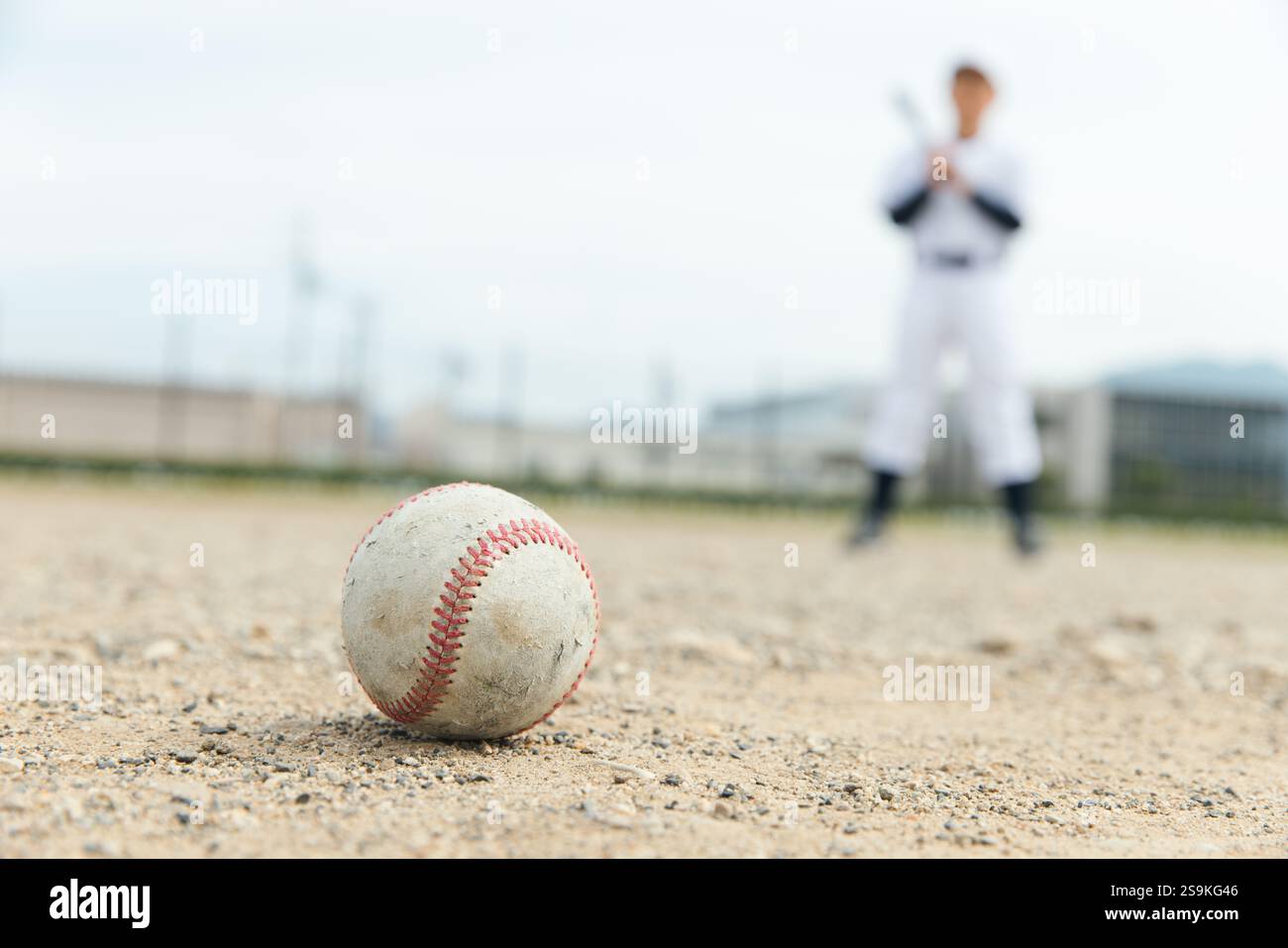 Baseball ball rolling on the ground Stock Photo - Alamy