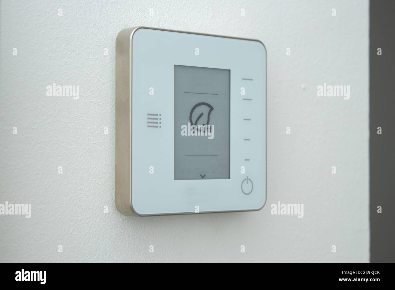 A modern electric thermostat control system on white wall Stock Photo ...