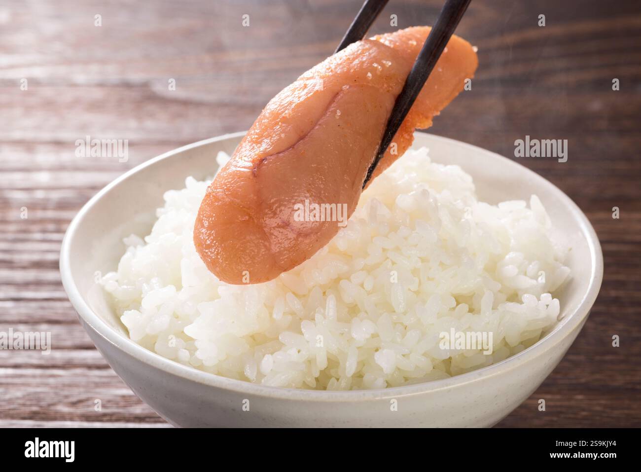 Put Karashi Mentaiko ( Spicy cod roe ) on white rice Stock Photo - Alamy