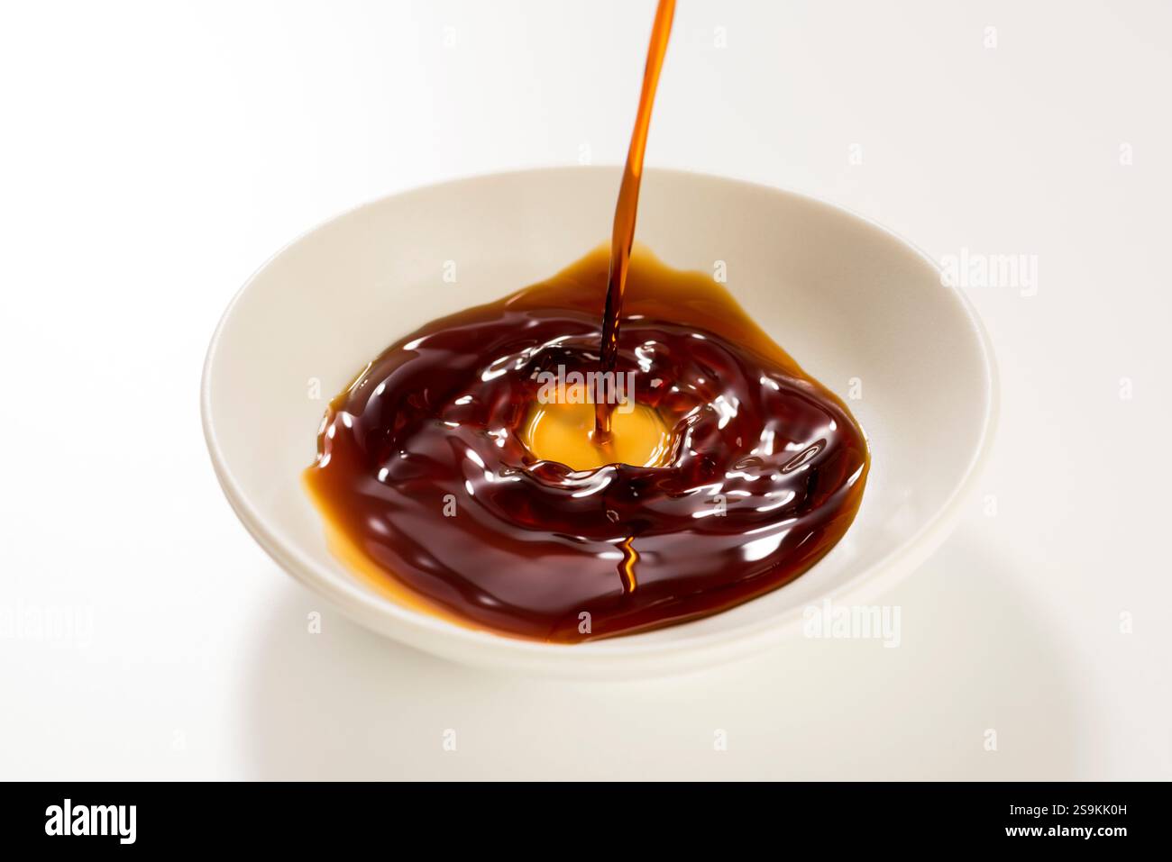 Soy sauce poured over bean dish Stock Photo - Alamy