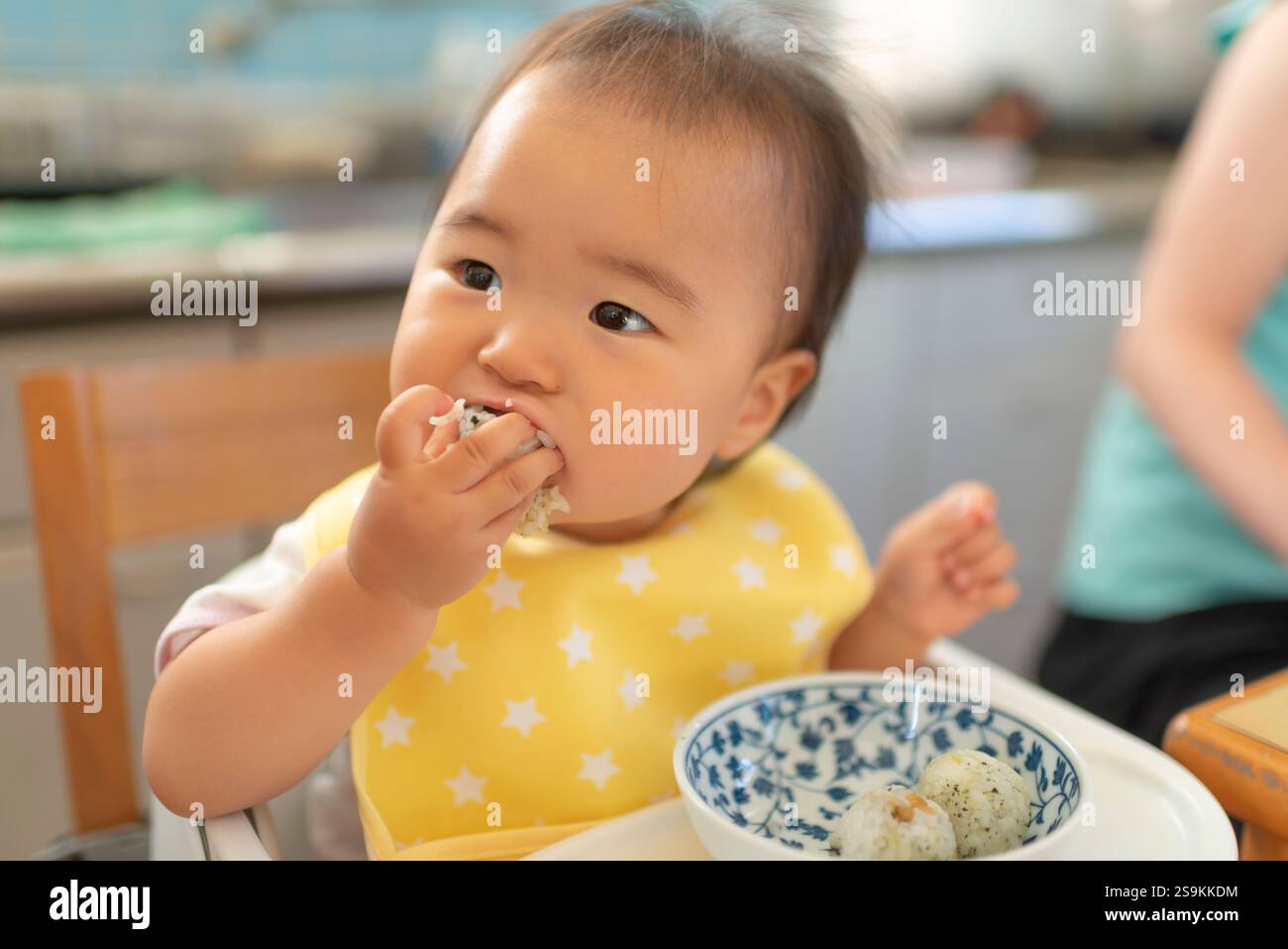Child eating a rice ball Stock Photo - Alamy