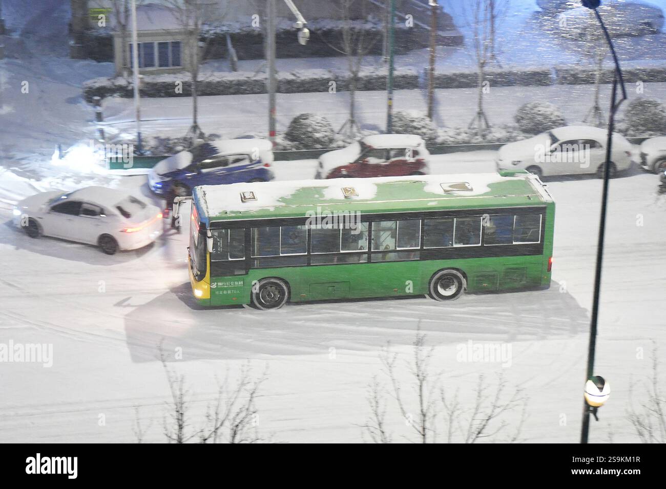 YANTAI, CHINA - JANUARY 27, 2025 - A bus runs in snow on Yongan Street ...