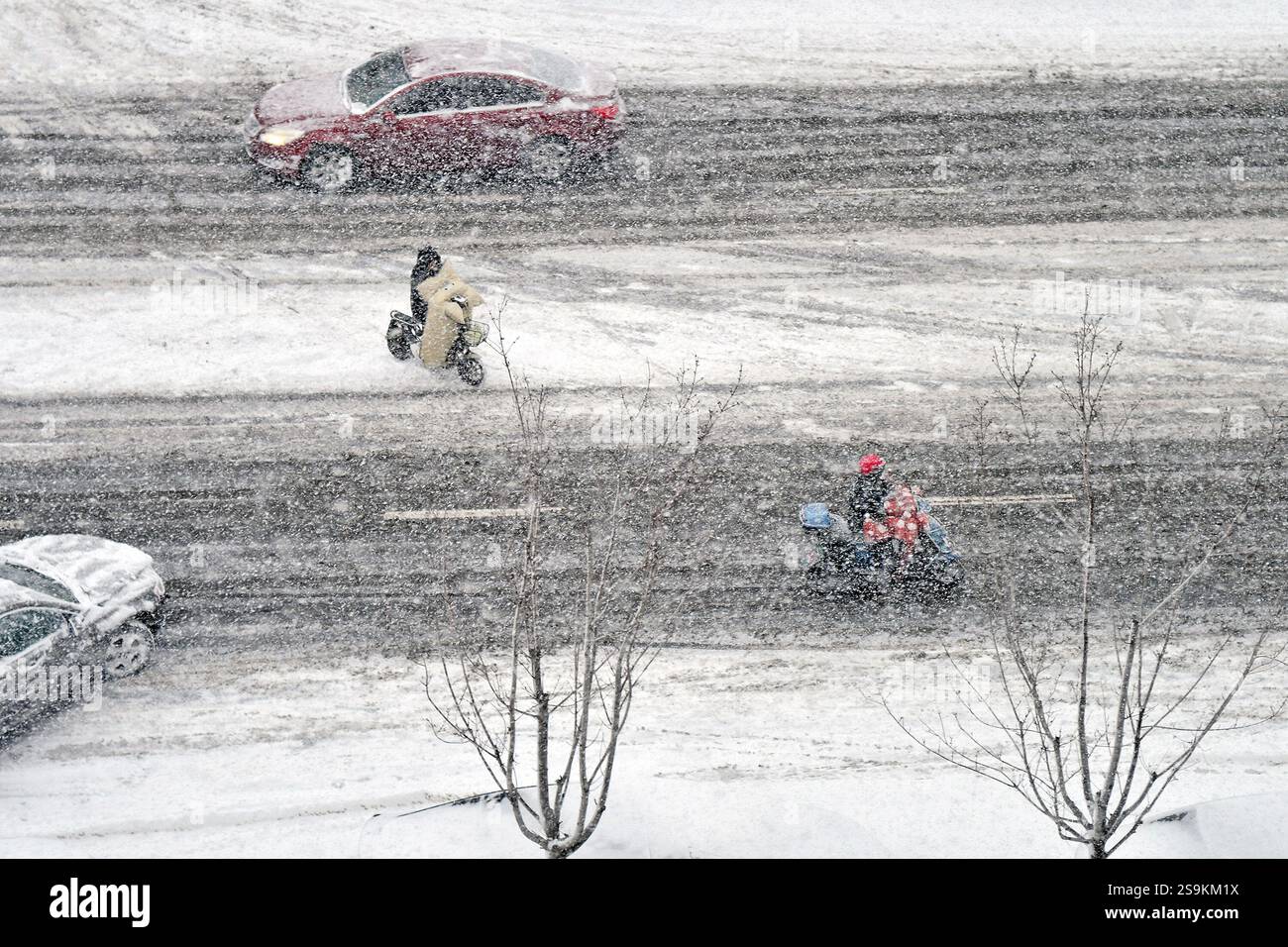 YANTAI, CHINA - JANUARY 27, 2025 - People travel in the snow on a ...