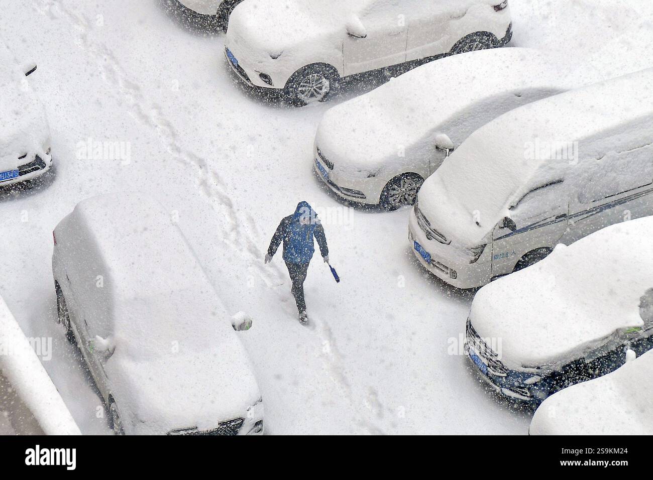 YANTAI, CHINA - JANUARY 27, 2025 - People travel in the snow on a ...