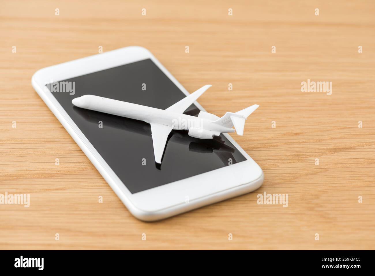 Smartphone and model aeroplane Stock Photo - Alamy