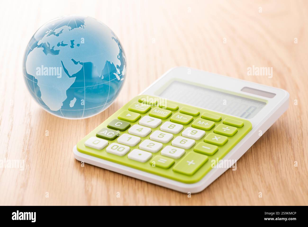 Globe and calculator Stock Photo - Alamy