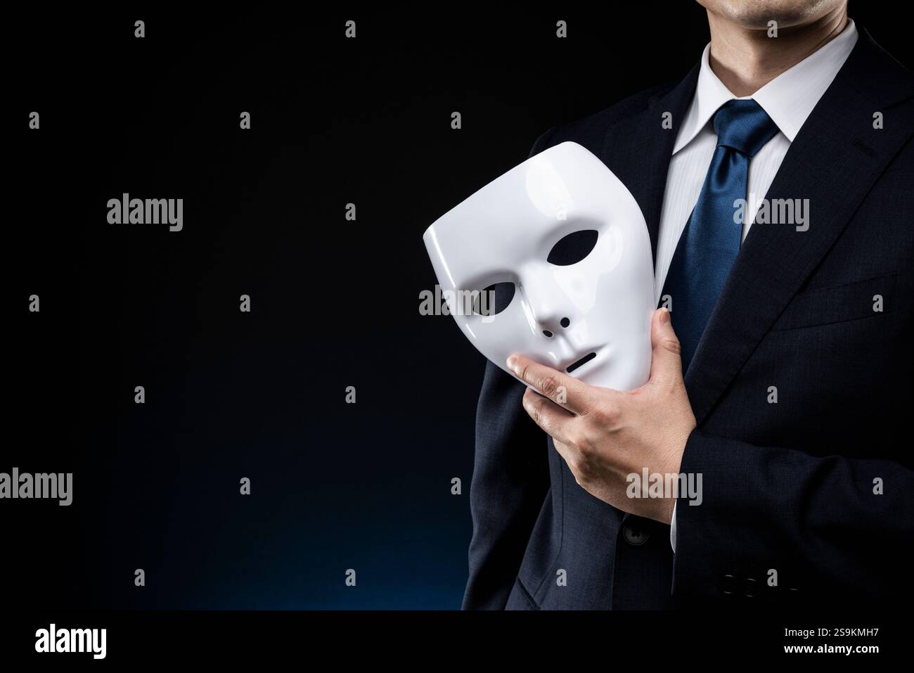 Masked man in suit Stock Photo - Alamy