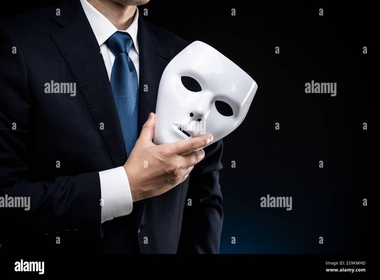 Masked man in suit Stock Photo - Alamy