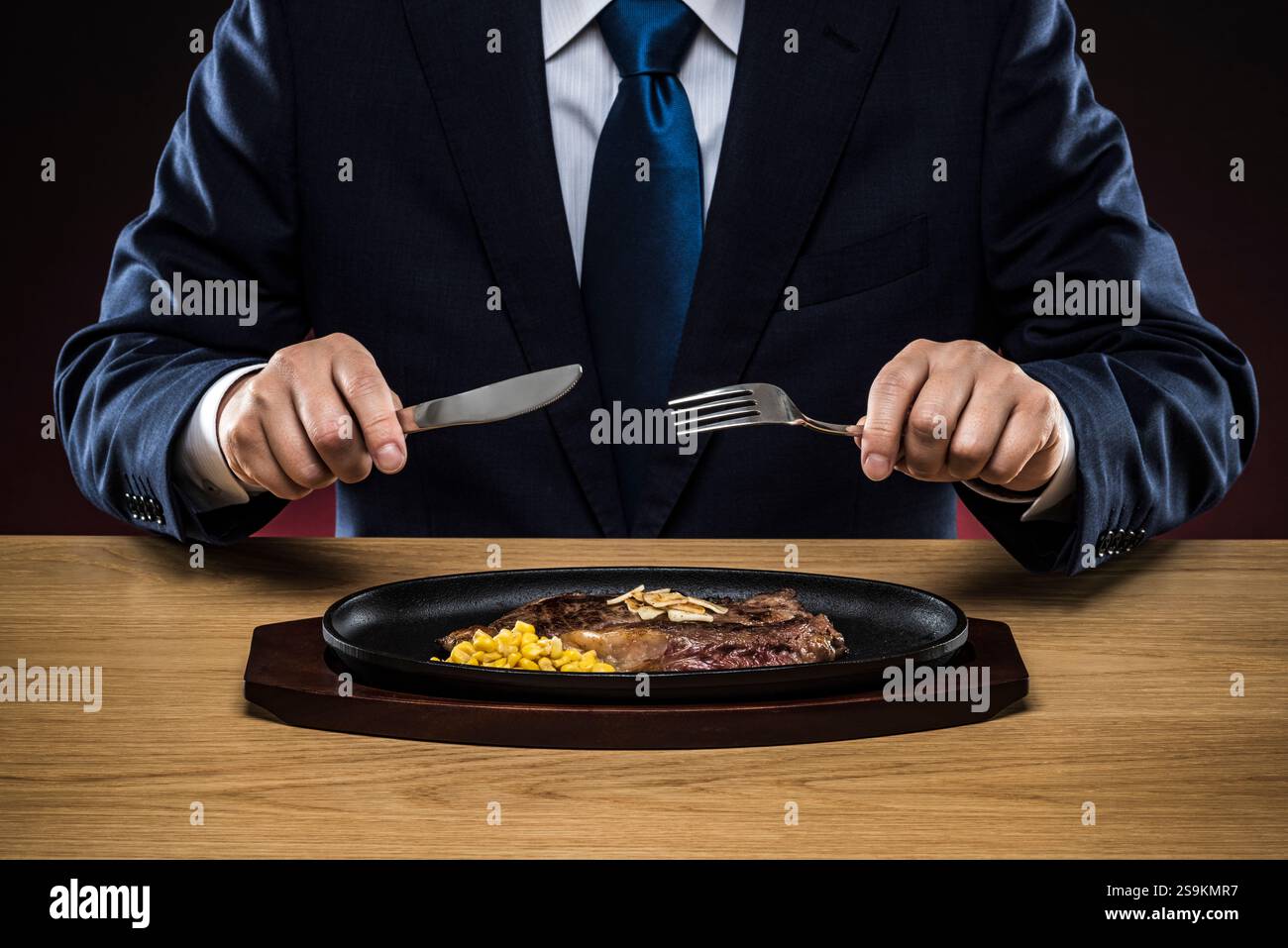 Eating steak in suit hi-res stock photography and images - Alamy