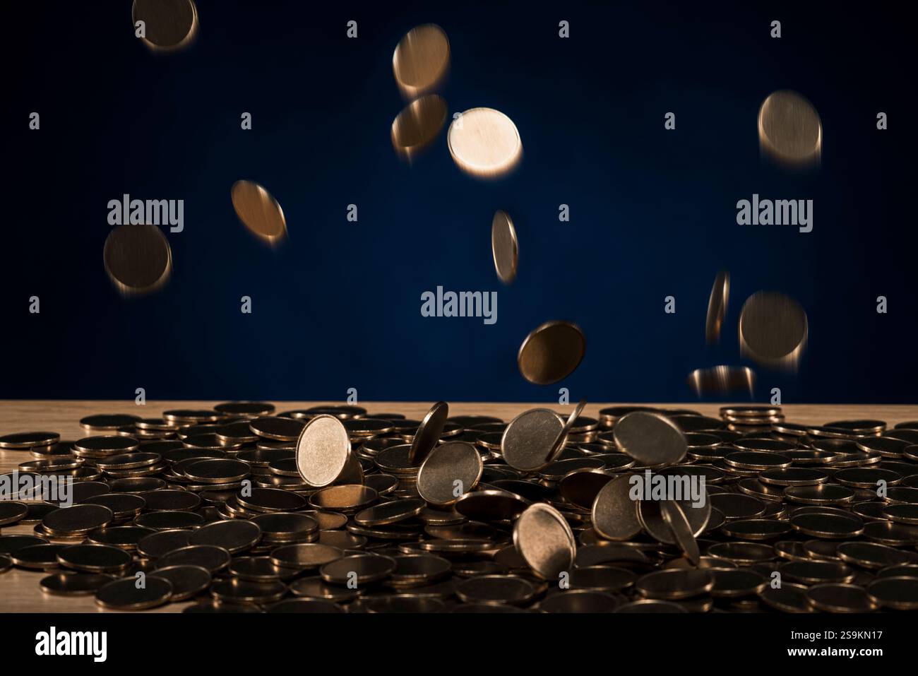 Gold coins falling Stock Photo - Alamy