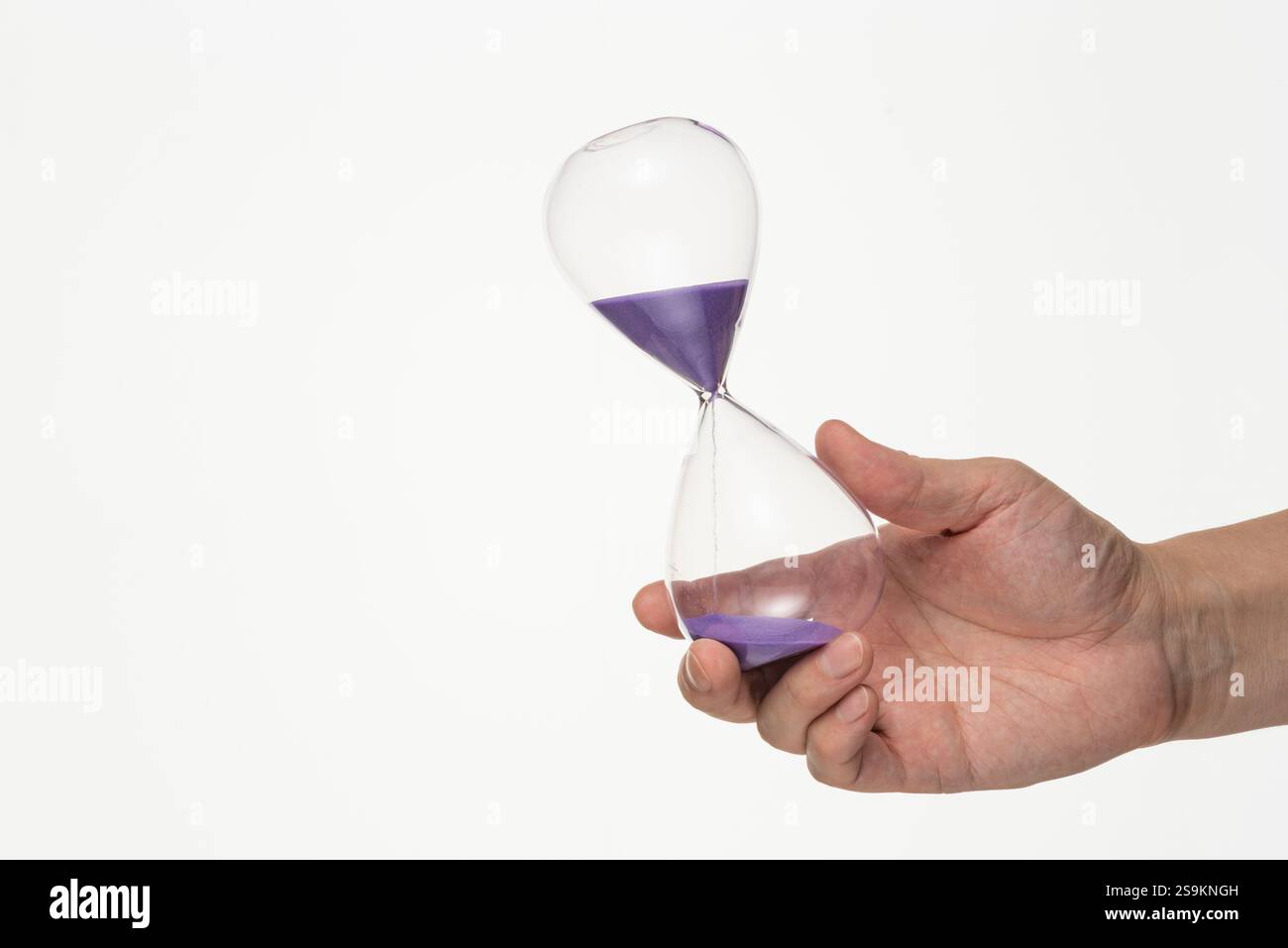 Hand holding hourglass Stock Photo - Alamy