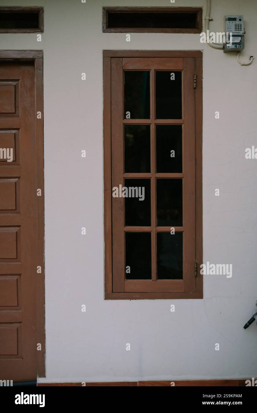 Simple brown window frame on a white wall Stock Photo - Alamy