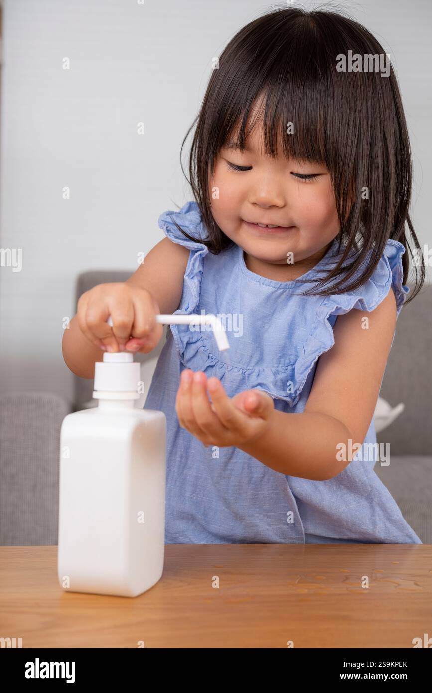 Child disinfecting with alcohol Infection control and prevention Stock ...