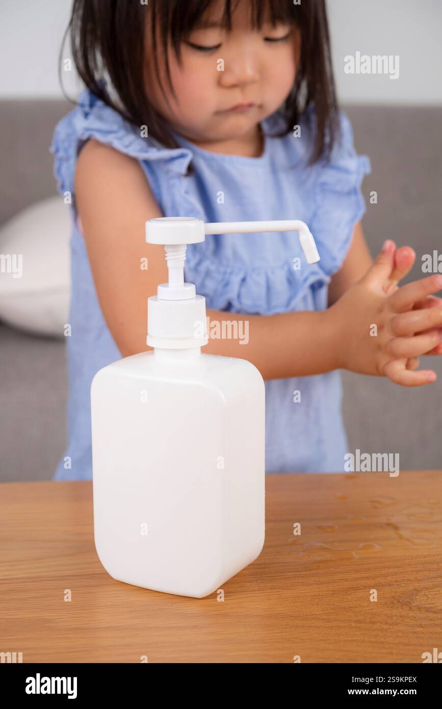 Child disinfecting with alcohol Infection control and prevention Stock ...