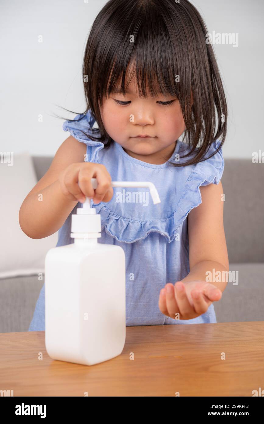 Child disinfecting with alcohol Infection control and prevention Stock ...