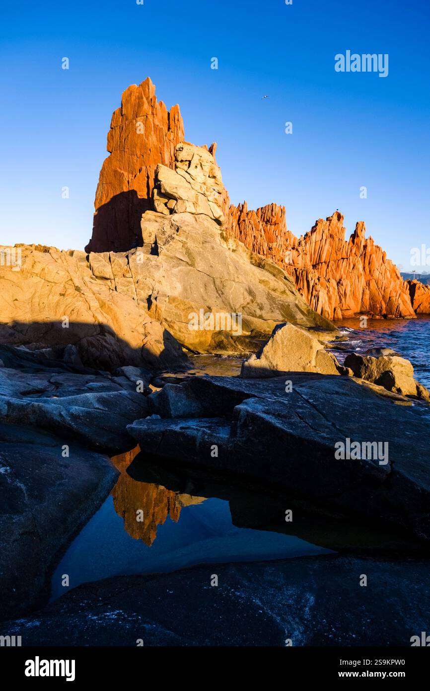 The blood-red and grey porphyry peaks of Arbatax, Rocce Rosse, are ...