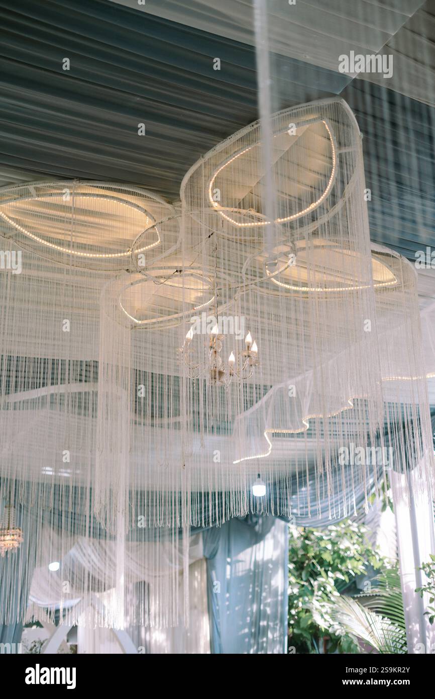 Decorative ceiling installation with white drapes and lights Stock ...