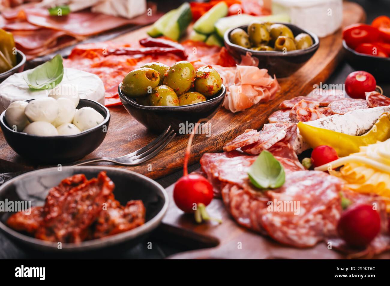 Assorted appetizers and antipasti platters on wooden tray, catering ...