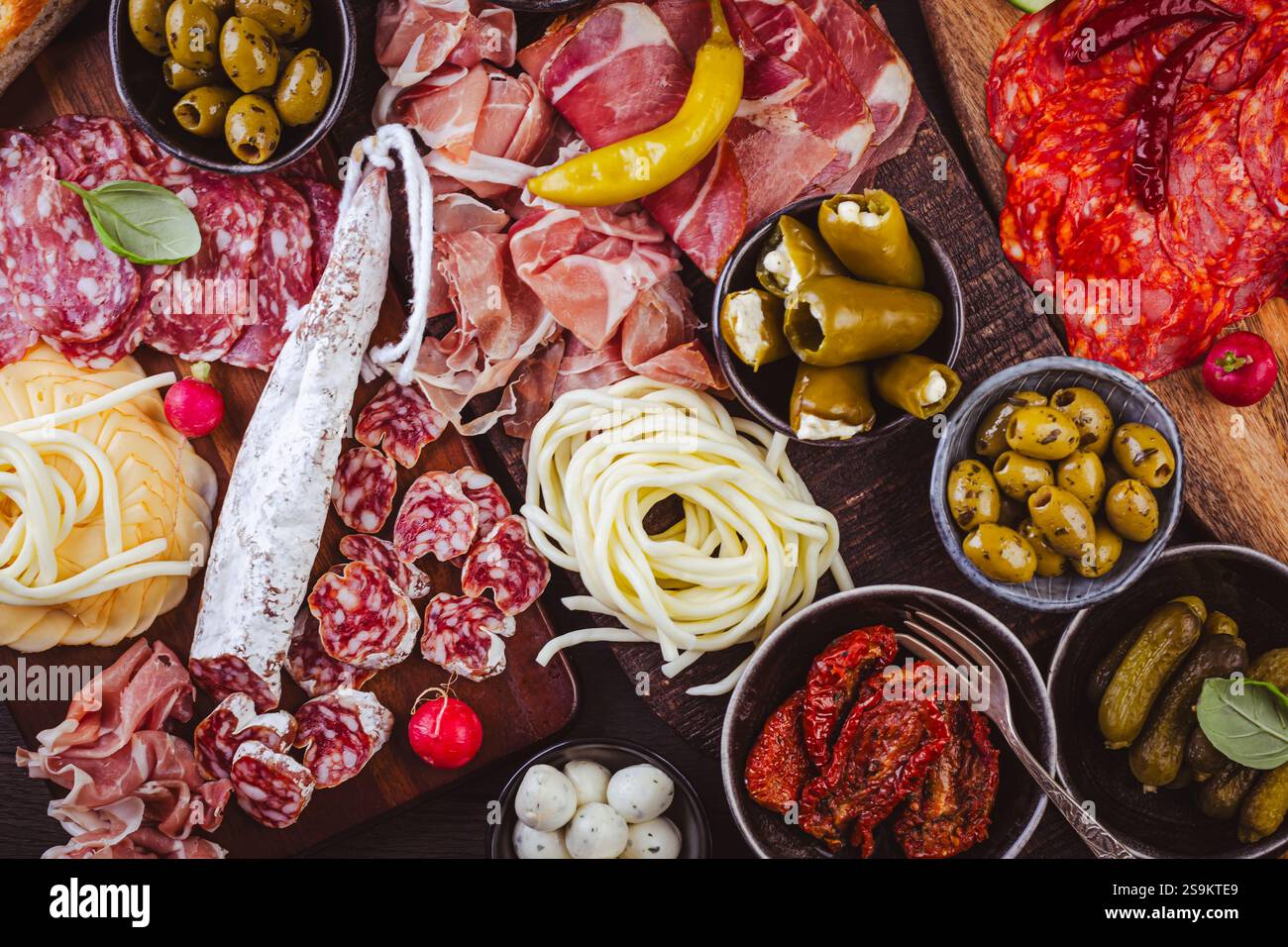Assorted appetizers and antipasti platters on wooden tray, catering ...