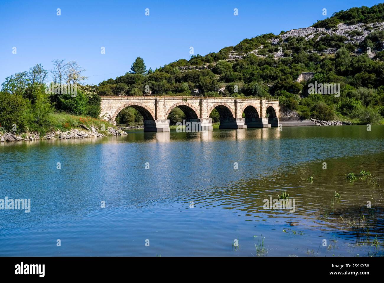 A railroad bridge crosses a tributary of the Lago San Sebastiano ...