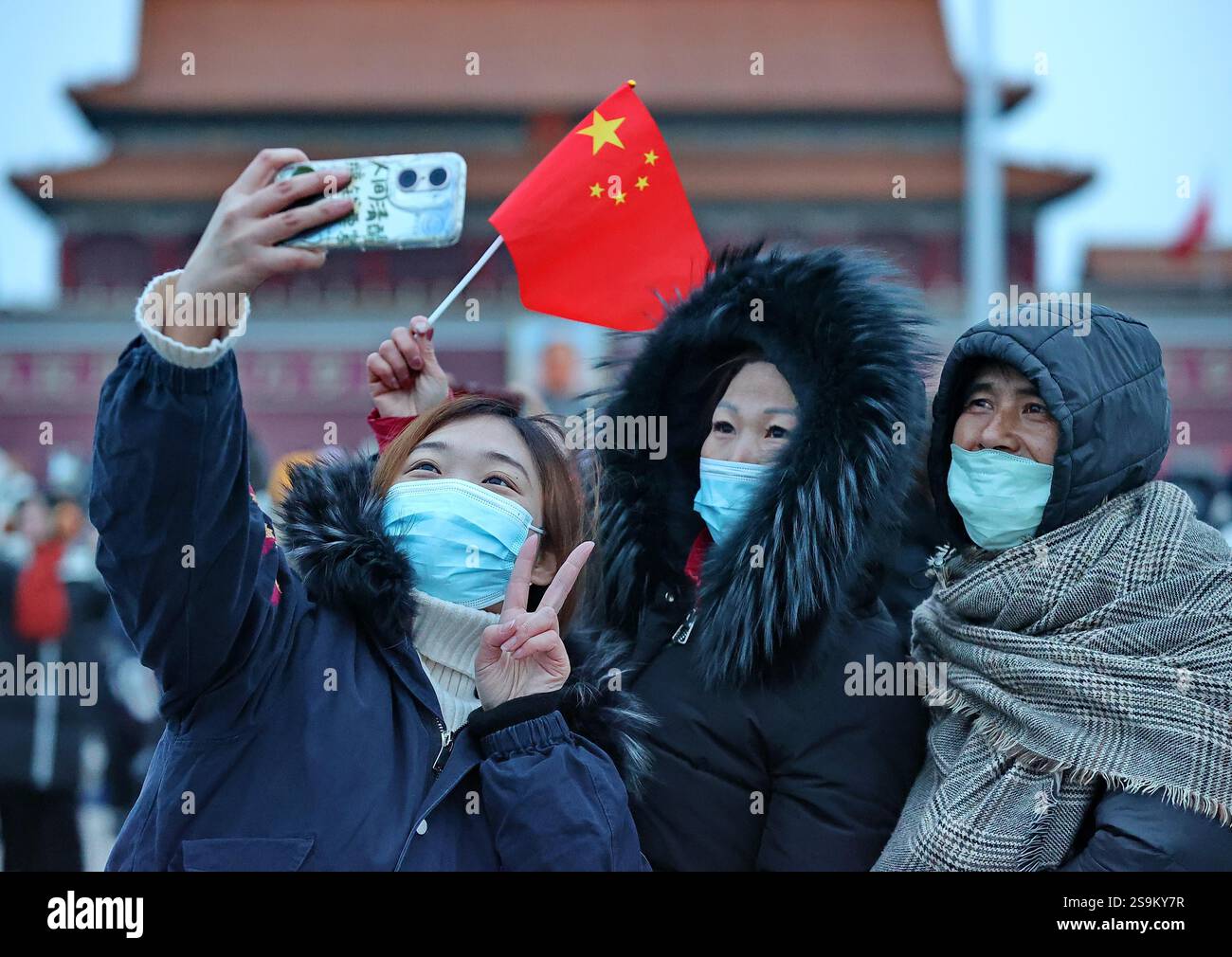 Tourists visit the Tiananmen Square amid cold air in Beijing, China, 26 ...