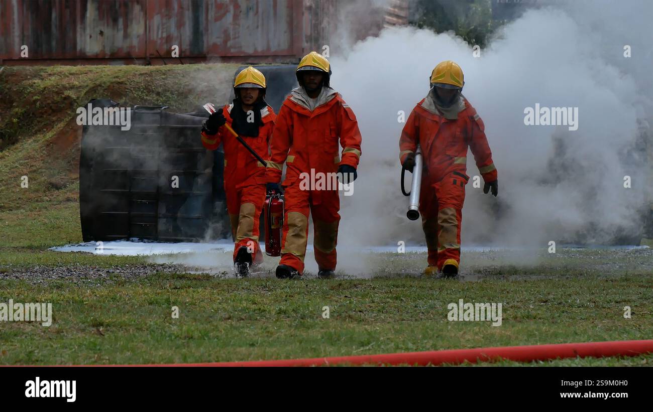 Firefighter fighting with flame using fire hose chemical water foam ...