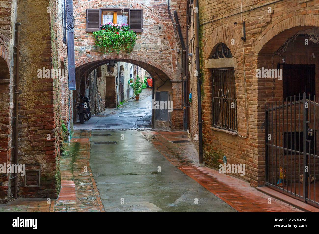 Arches on an Italian back street in a city Stock Photo - Alamy