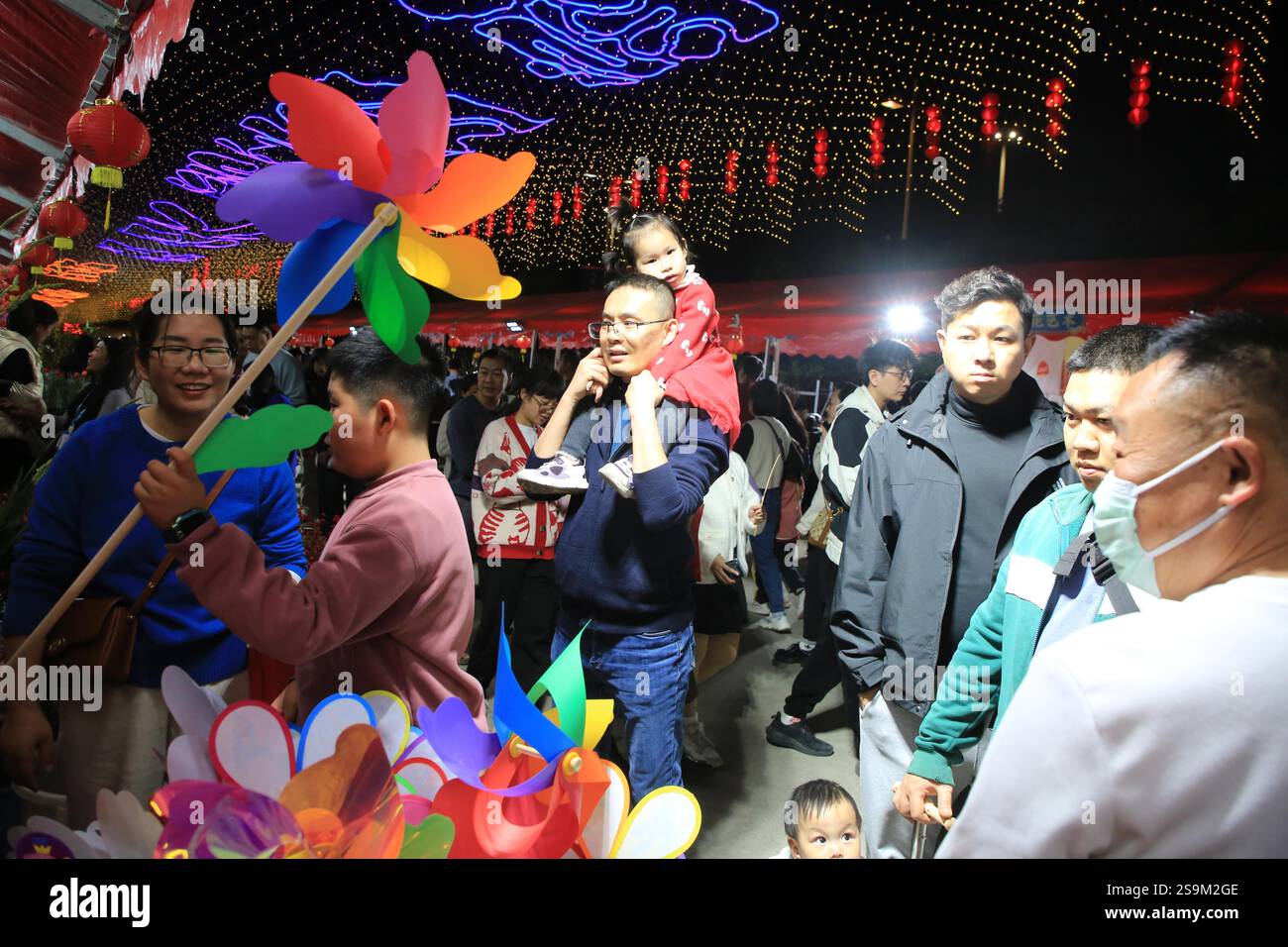 People stroll in a flower street in Guangzhou City, south China's ...