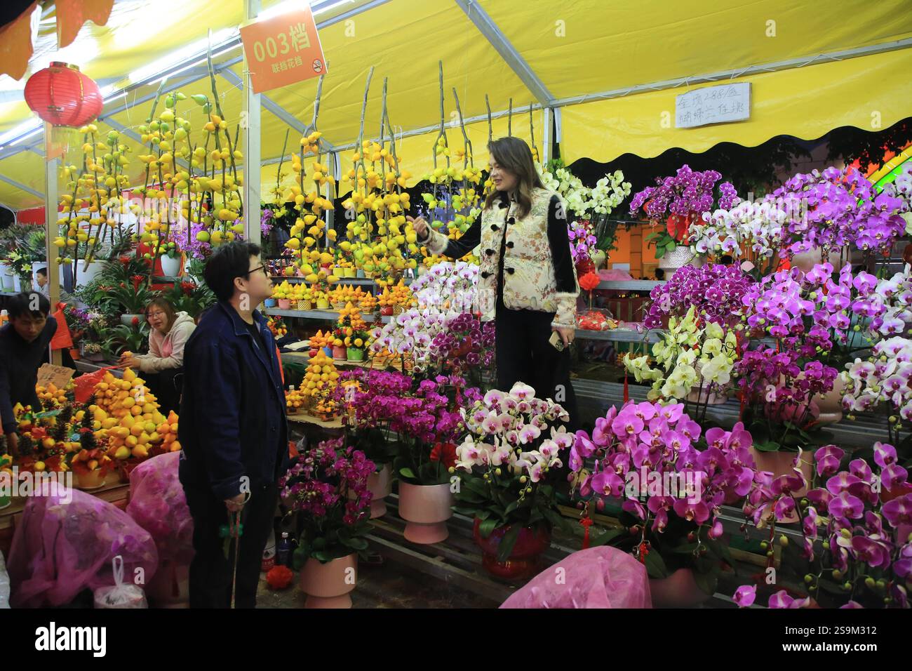 People stroll in a flower street in Guangzhou City, south China's ...