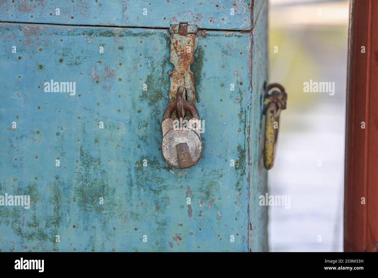 Beautiful rusty yellow padlock on a grey-green oxidized metal trunk ...