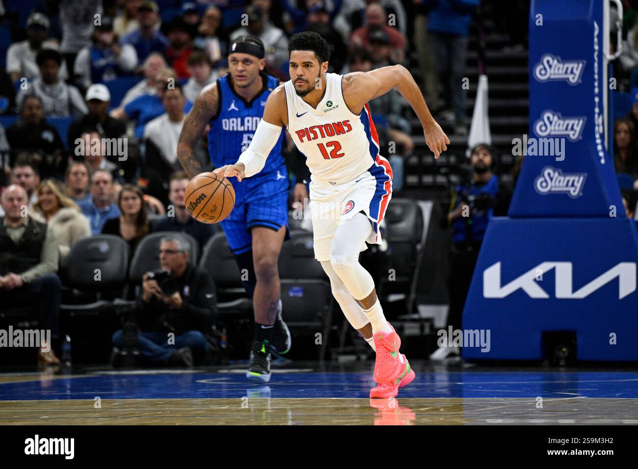 Detroit Pistons forward Tobias Harris (12) brings the ball up the court as Orlando Magic forward ...