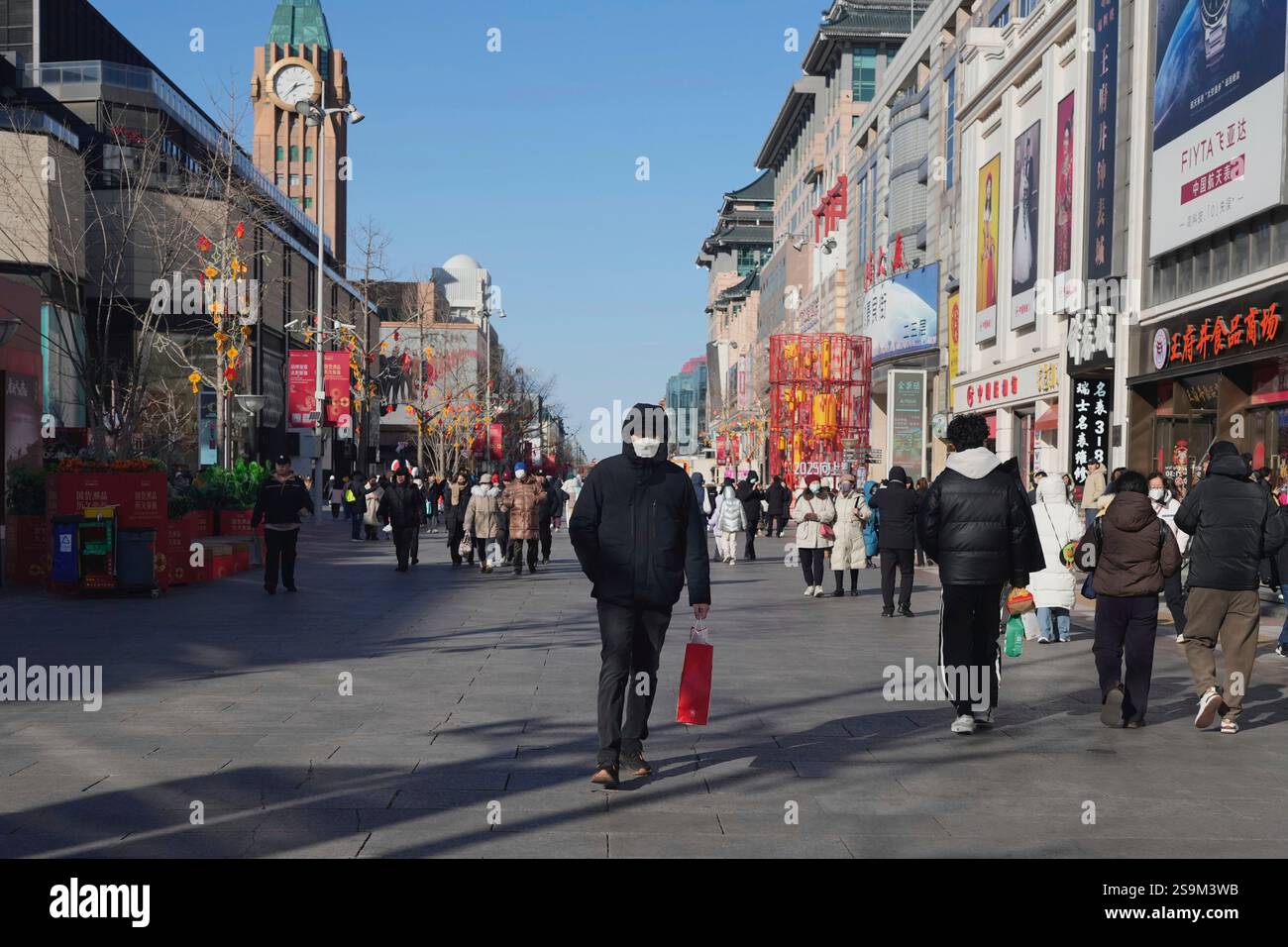 People shop at a commercial district in Beijing on Monday Jan. 27, 2025. (AP Photo/Aaron Favila ...