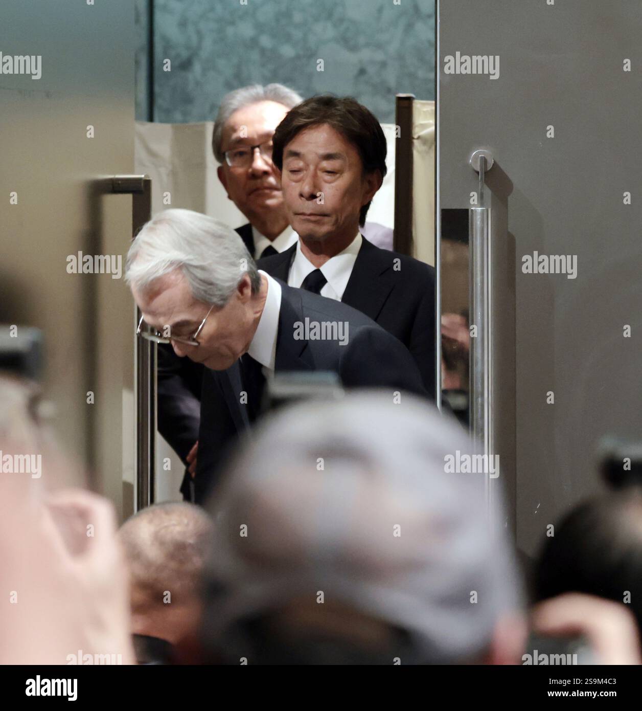 Fuji Television President Koichi Minato (C) and Chairman Shuji Kano ...