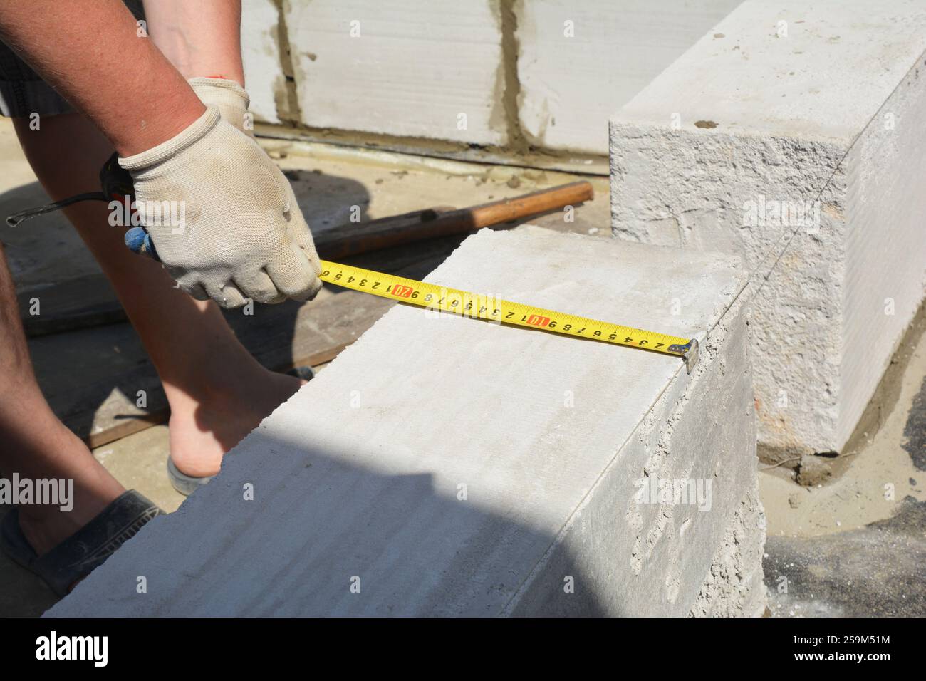 Builder contractor laying and checking white autoclaved aerated ...