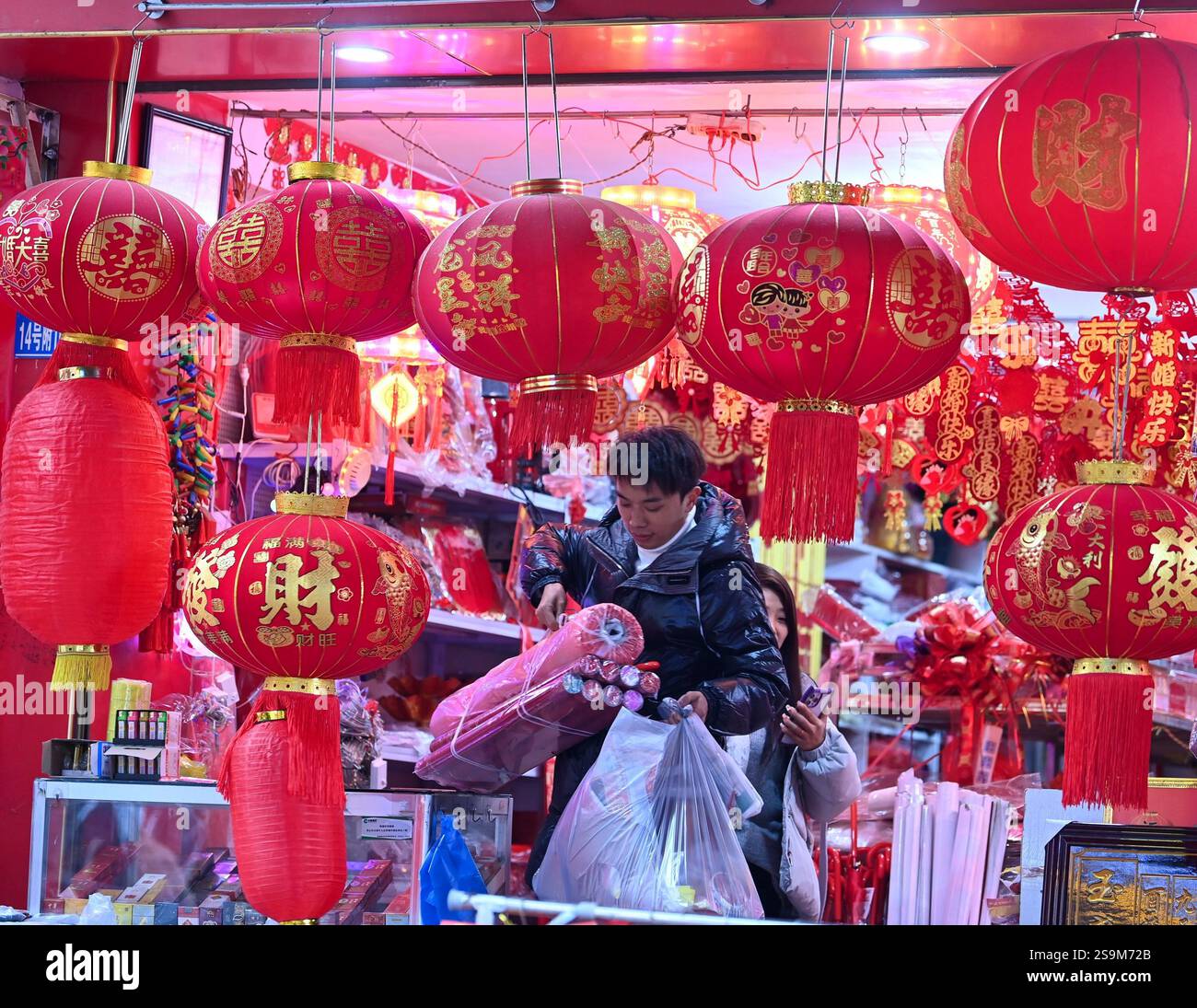 People select Spring Festival decorations at a market in Chongqing ...