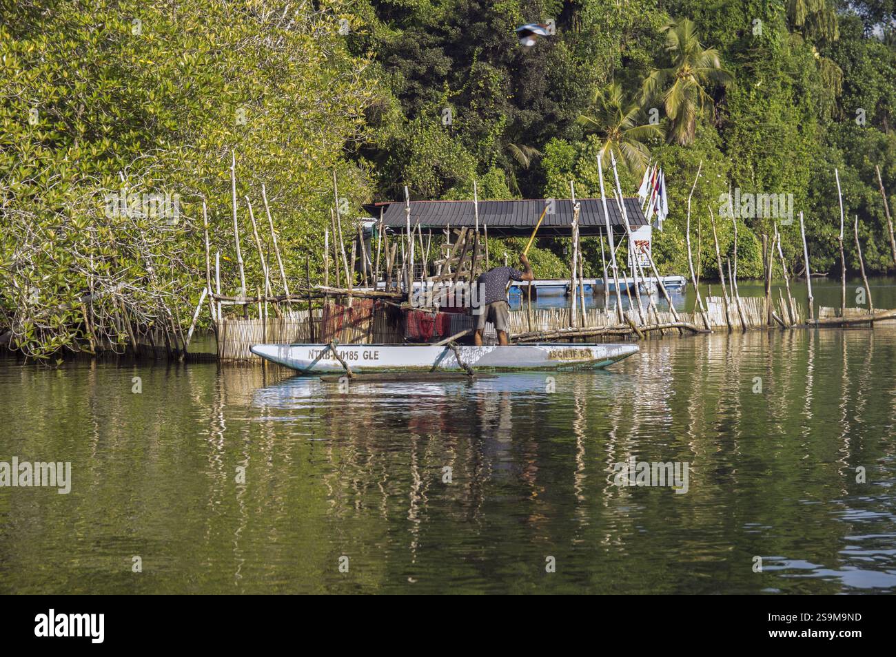 Faceless image of a fisherman with his back to the camera preparing to ...