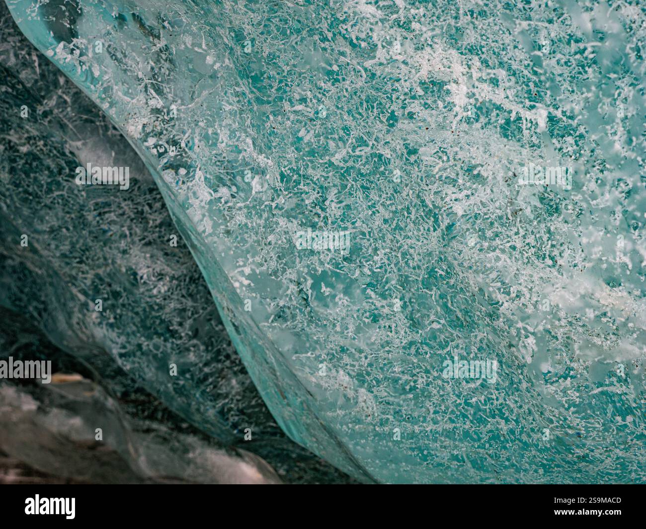 Mountain glacier ice. Rounded shapes and rich turquoise color and ...