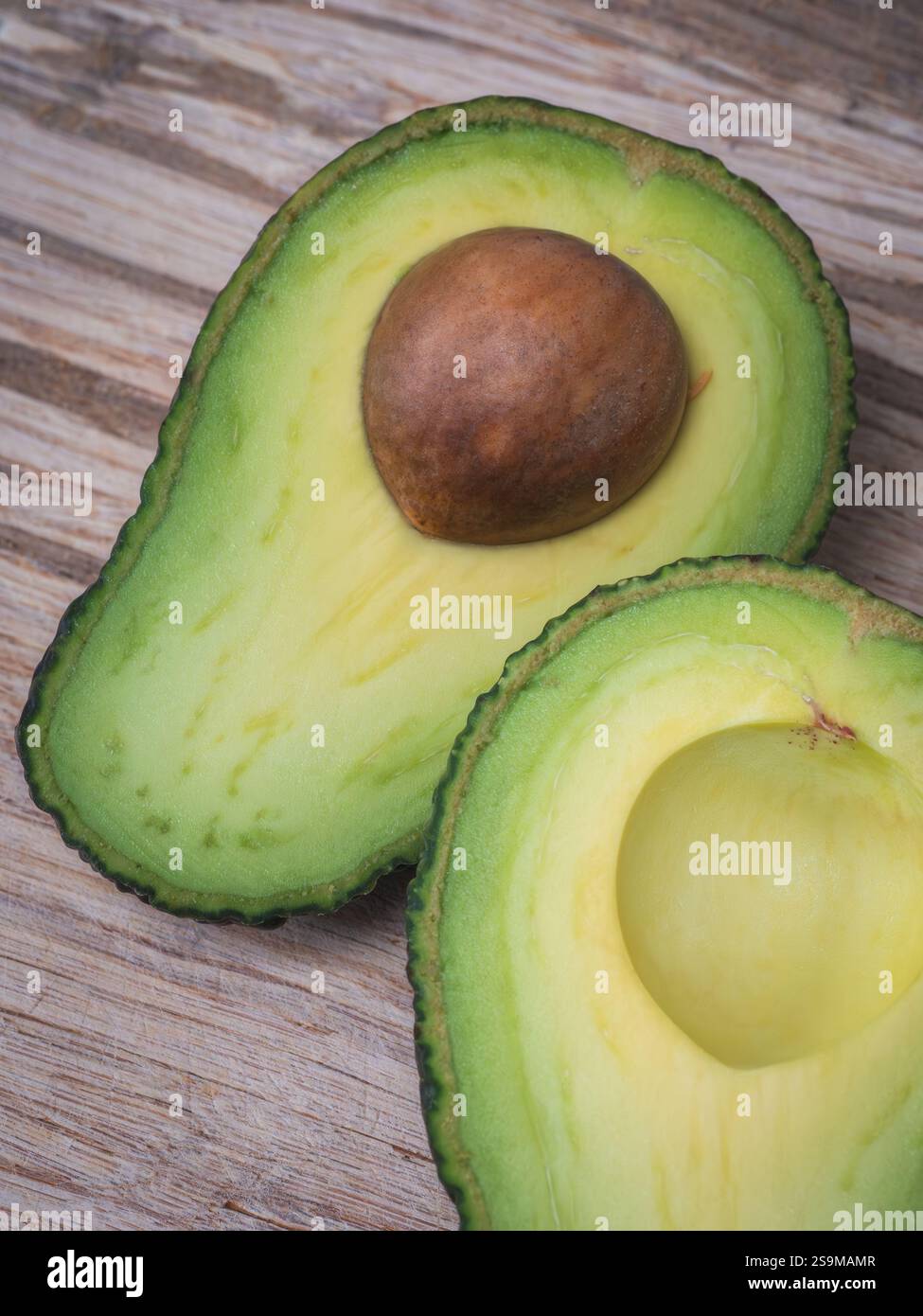 A single avocado fruit cut in half Stock Photo - Alamy