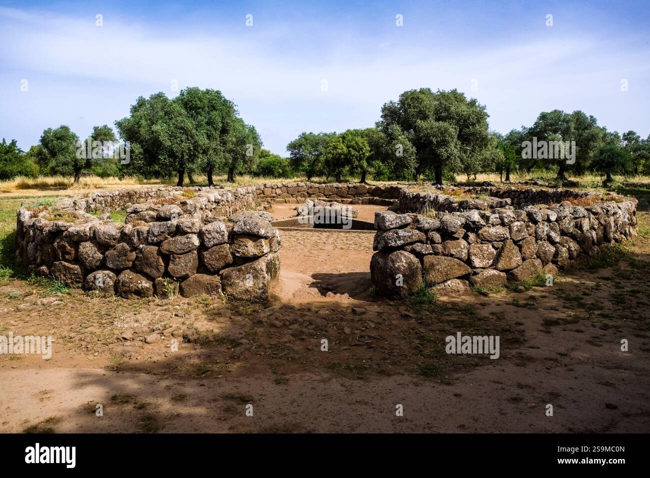Rock walls and ruins of the Santuario nuragico di Santa Cristina, a ...