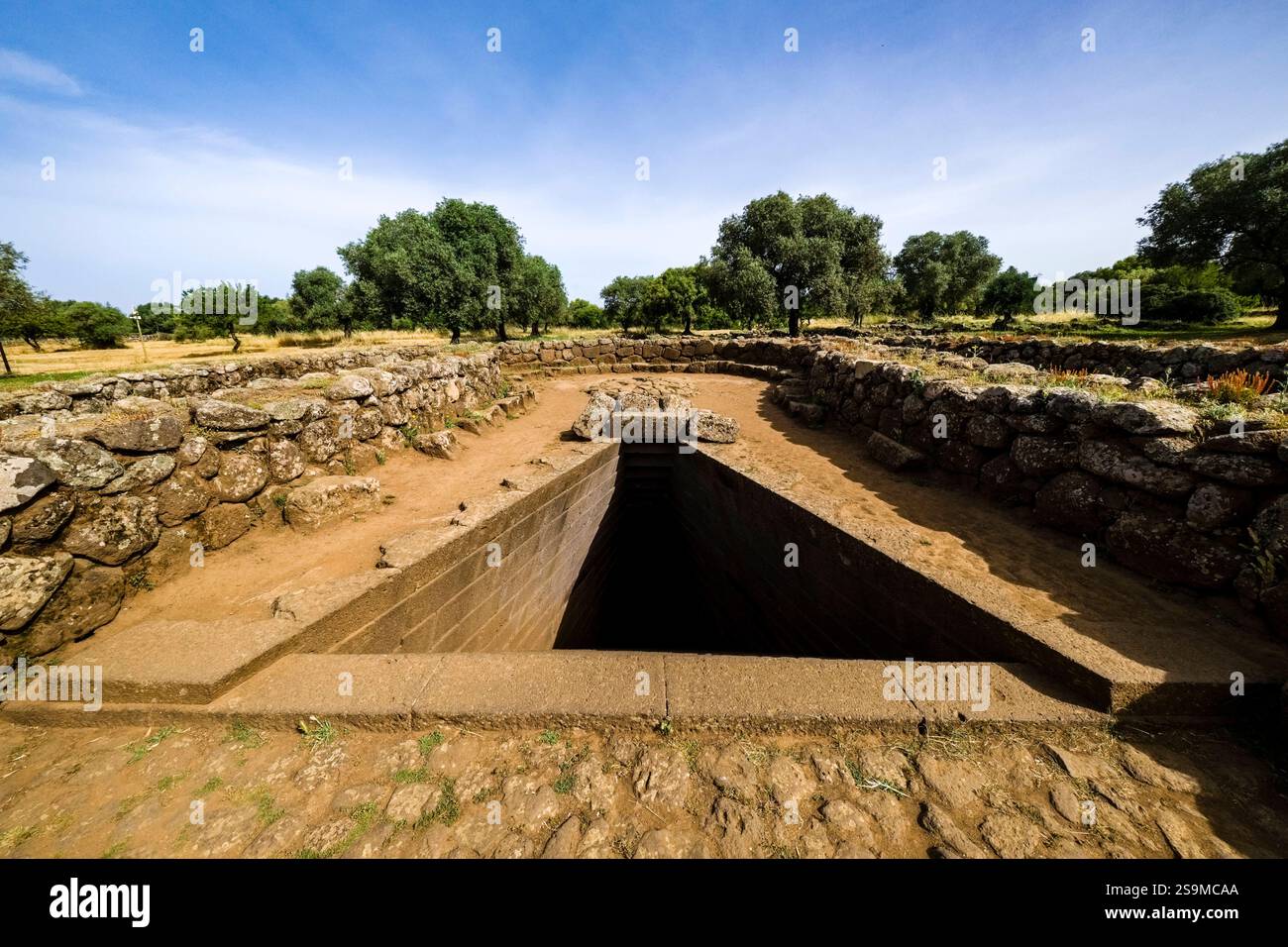 Rock walls and ruins of the Santuario nuragico di Santa Cristina, a ...