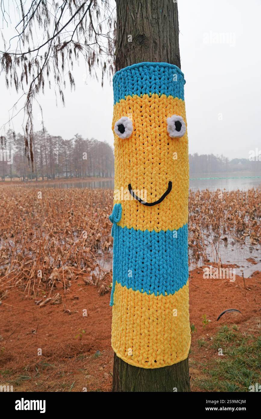Trees on the street are put on brightly colored "sweaters" for winter ...