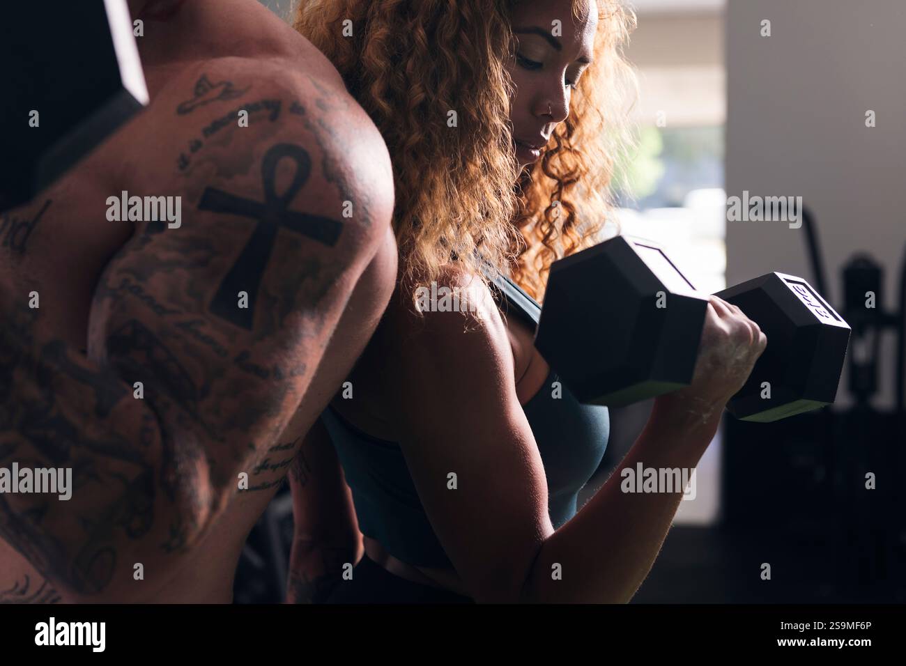 Sportswoman near strong bodybuilder hi-res stock photography and images ...