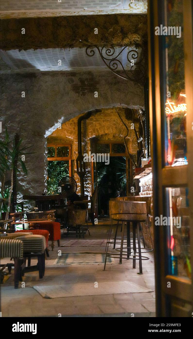 Warm and inviting space highlighted by stone walls, wooden furniture ...