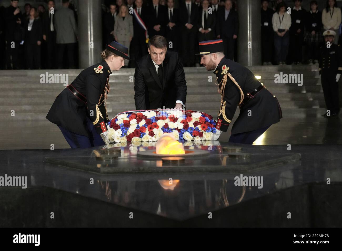 French President Emmanuel Macron lays a wreath of flowers at the Paris ...